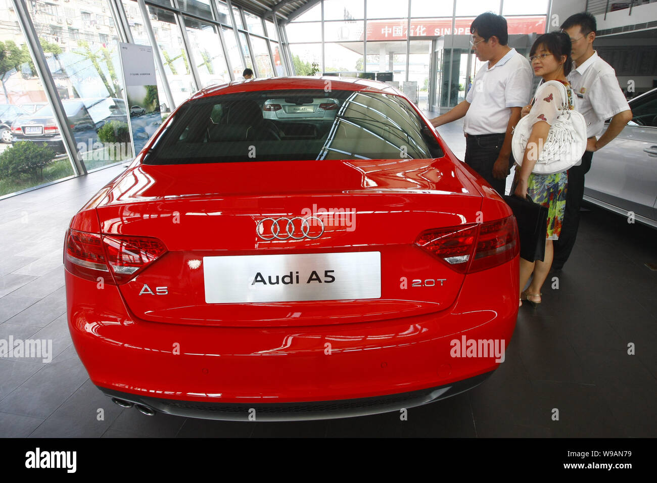 --FILE--Chinese car buyers look at an Audi A5 in a dealership in ...