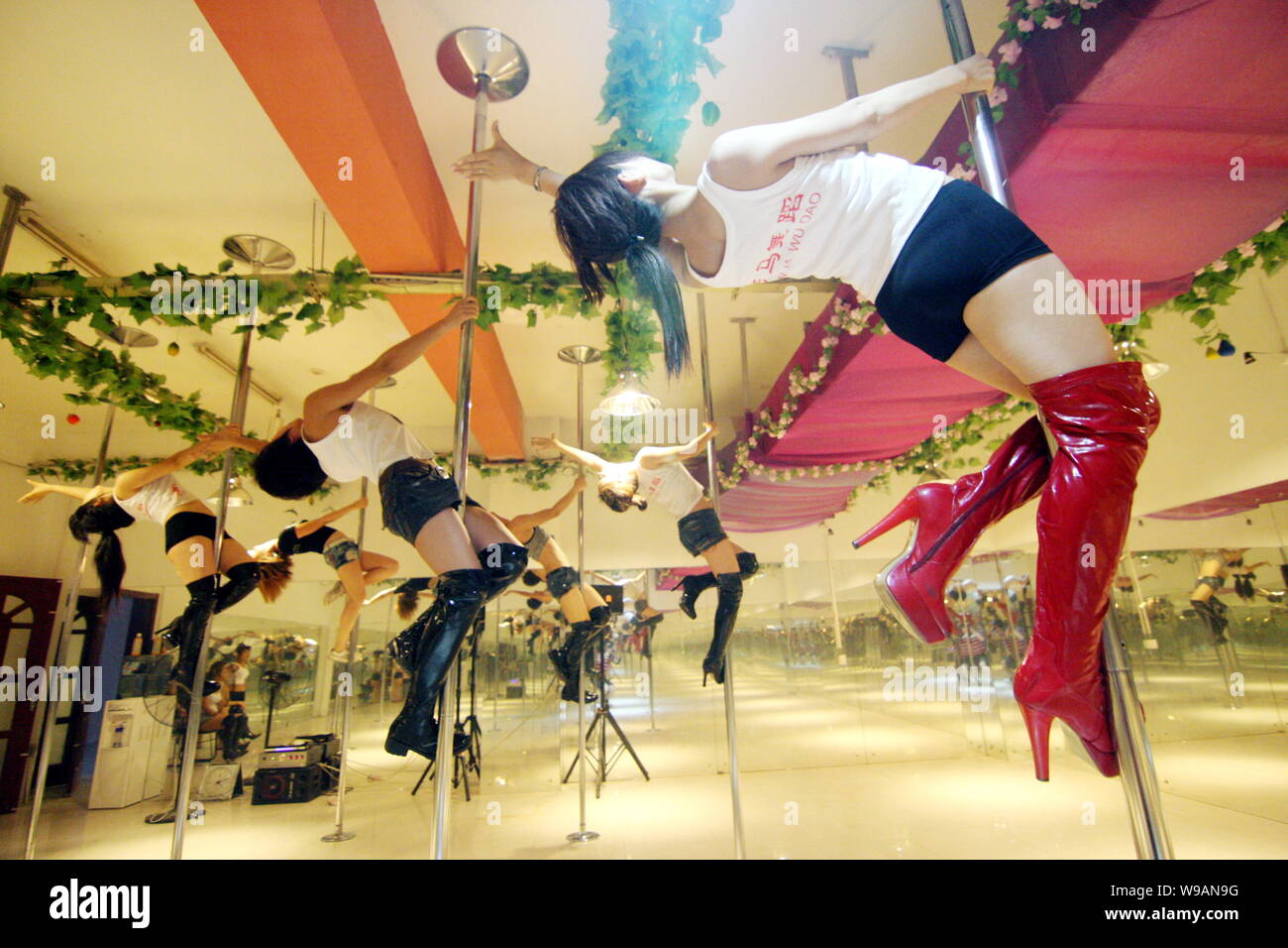 Young Chinese people learn pole dancing at a dance school in Jinan city ...