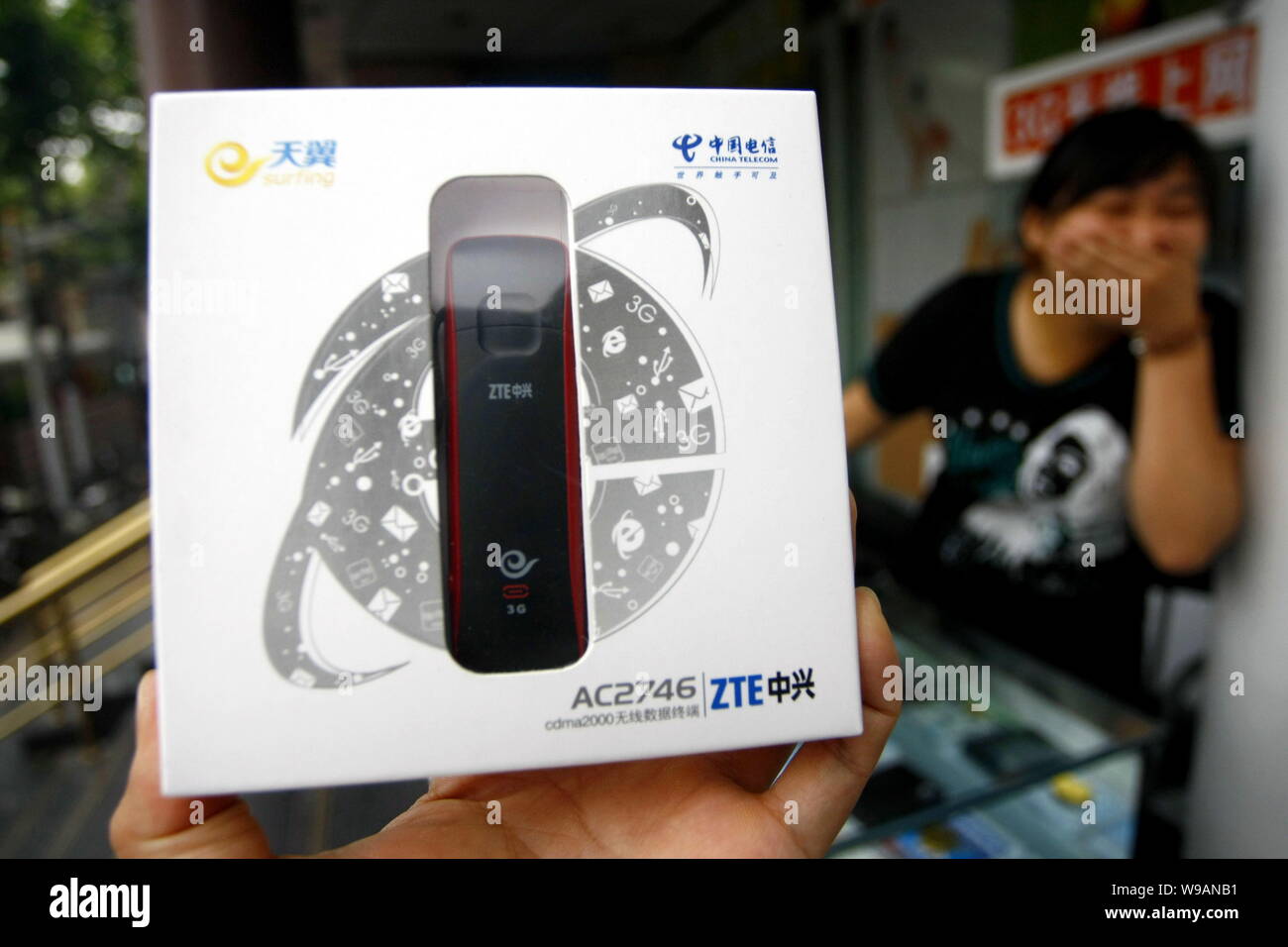 A man shows a ZTE wireless modem at a telecommunication products mall ...