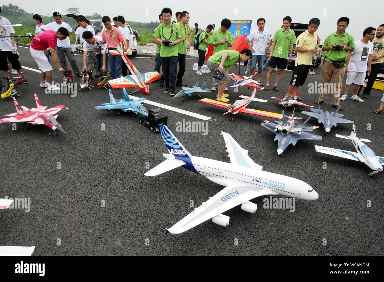 Chinese aeromodellers look at a model of Airbus A380 and other model ...