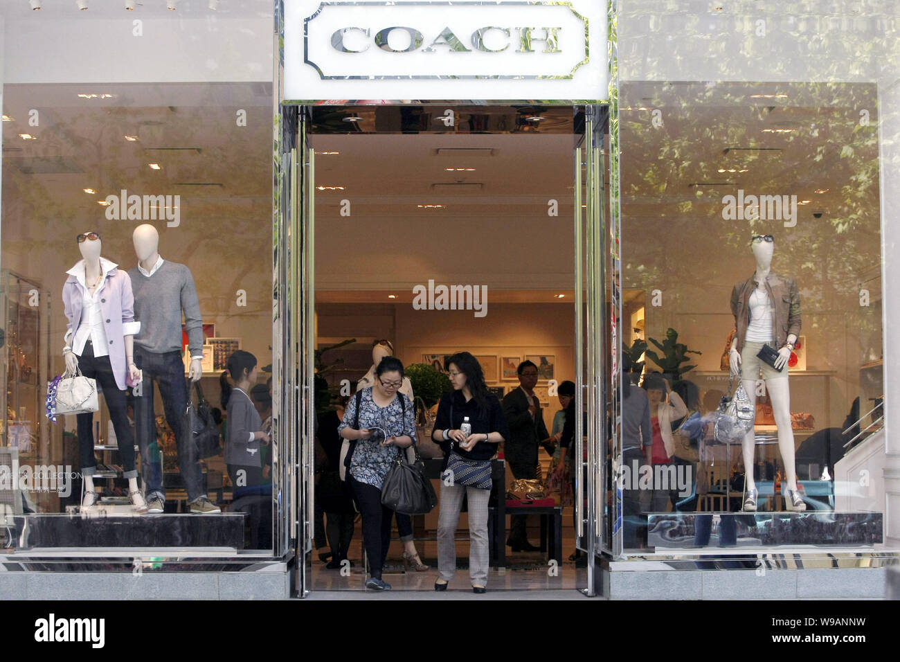--FILE--Customers walk out of the COACH boutique at the Hong Kong Plaza ...