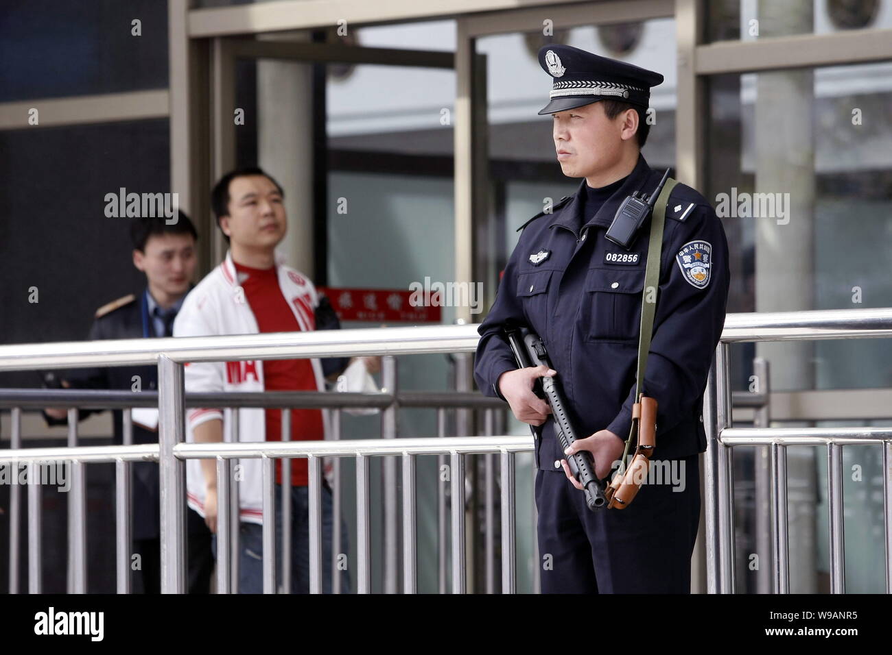 An armed Chinese policeman stands guard at the Shanghai Railway Station ...