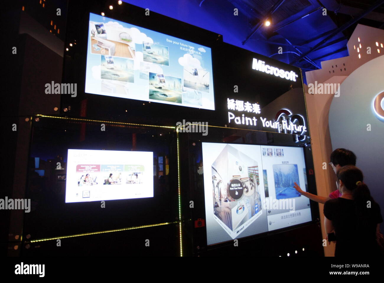 Visitors try an installation of Microsoft in the USA Pavilion in the ...