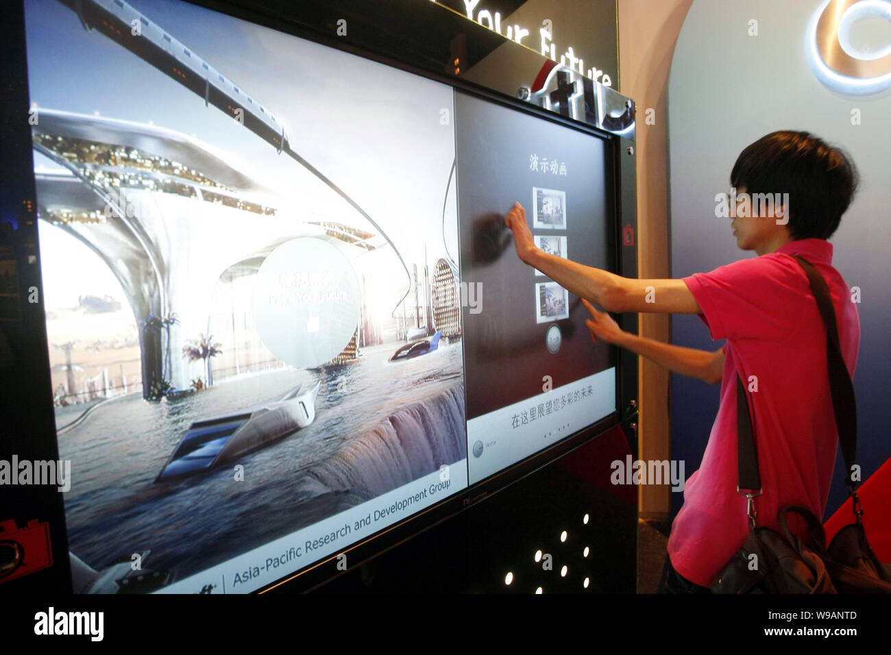 Visitors try an installation of Microsoft in the USA Pavilion in the ...