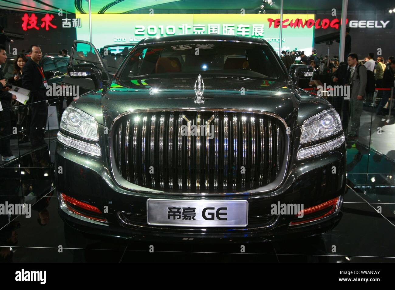 Visitors look at a Geely Emgrand GE during the 11th Beijing ...