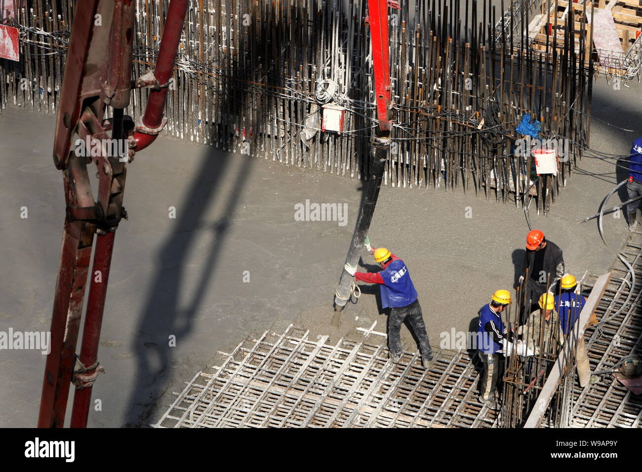 Chinese construction workers concrete the foundation of the Shanghai ...