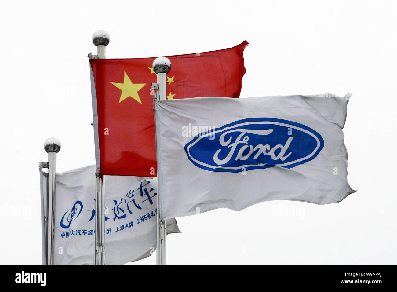 The Chinese and Ford flags flutter outside a Ford dealership in ...