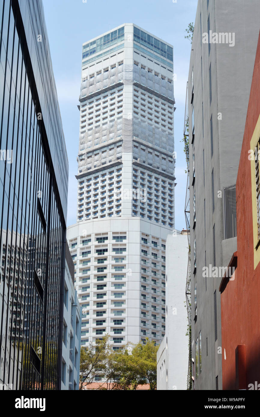 High-rise skyscraper between two tall modern buildings in downtown ...