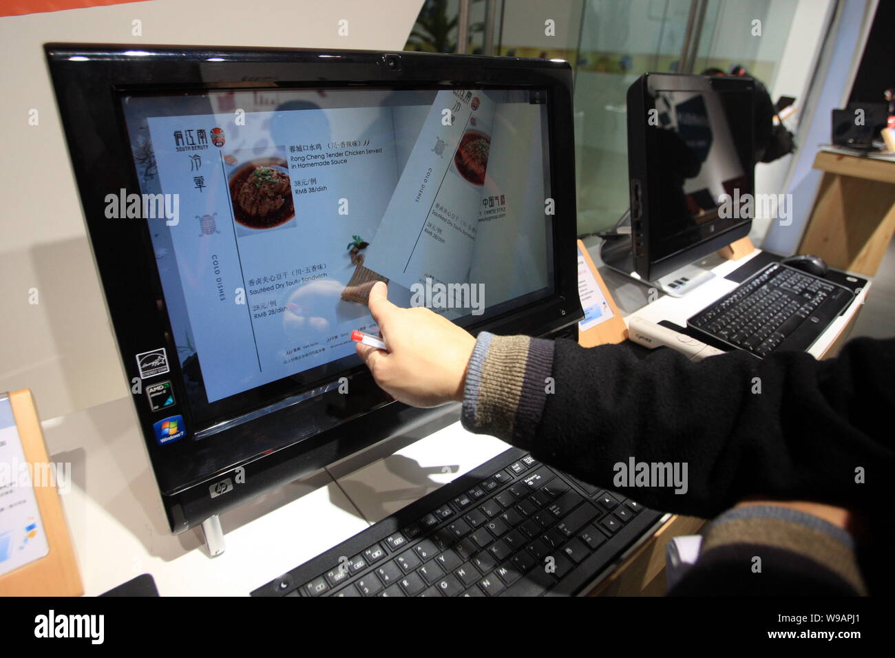 A visitor tries out an HP computer which was made at HP Chongqing PC ...