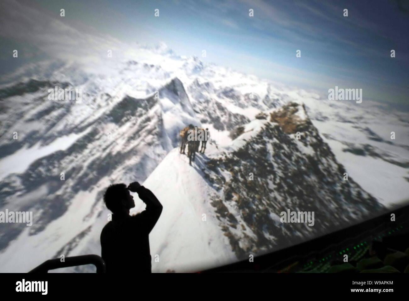 A visitor watches the worlds biggest IMAX screen at the new China ...