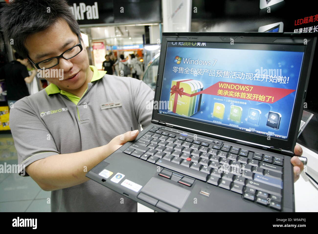 --FILE--A Chinese man shows a laptop computer installed with Microsoft ...
