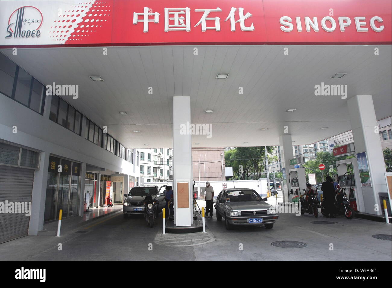 Cars are being refueled at a gas station of Sinopec, also known as ...