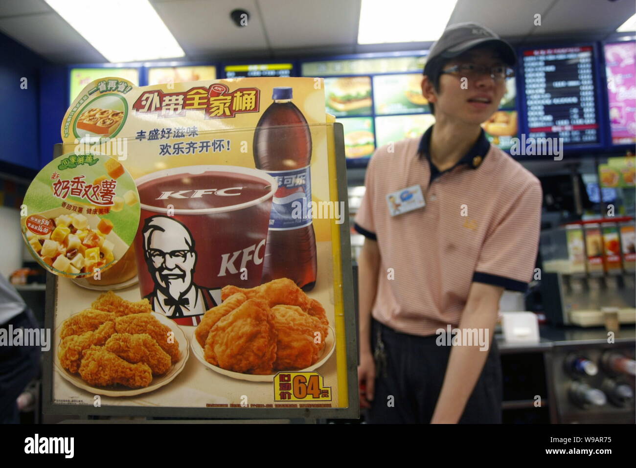 --FILE-- A KFC employee stands at the counter of a KFC restaurant in ...
