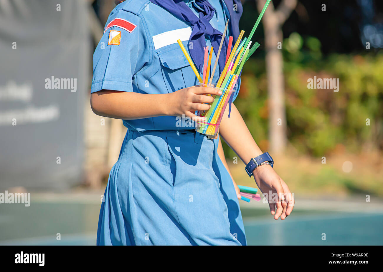Hand Asean girl holding a glass of waste plastic and Drinking straws ...