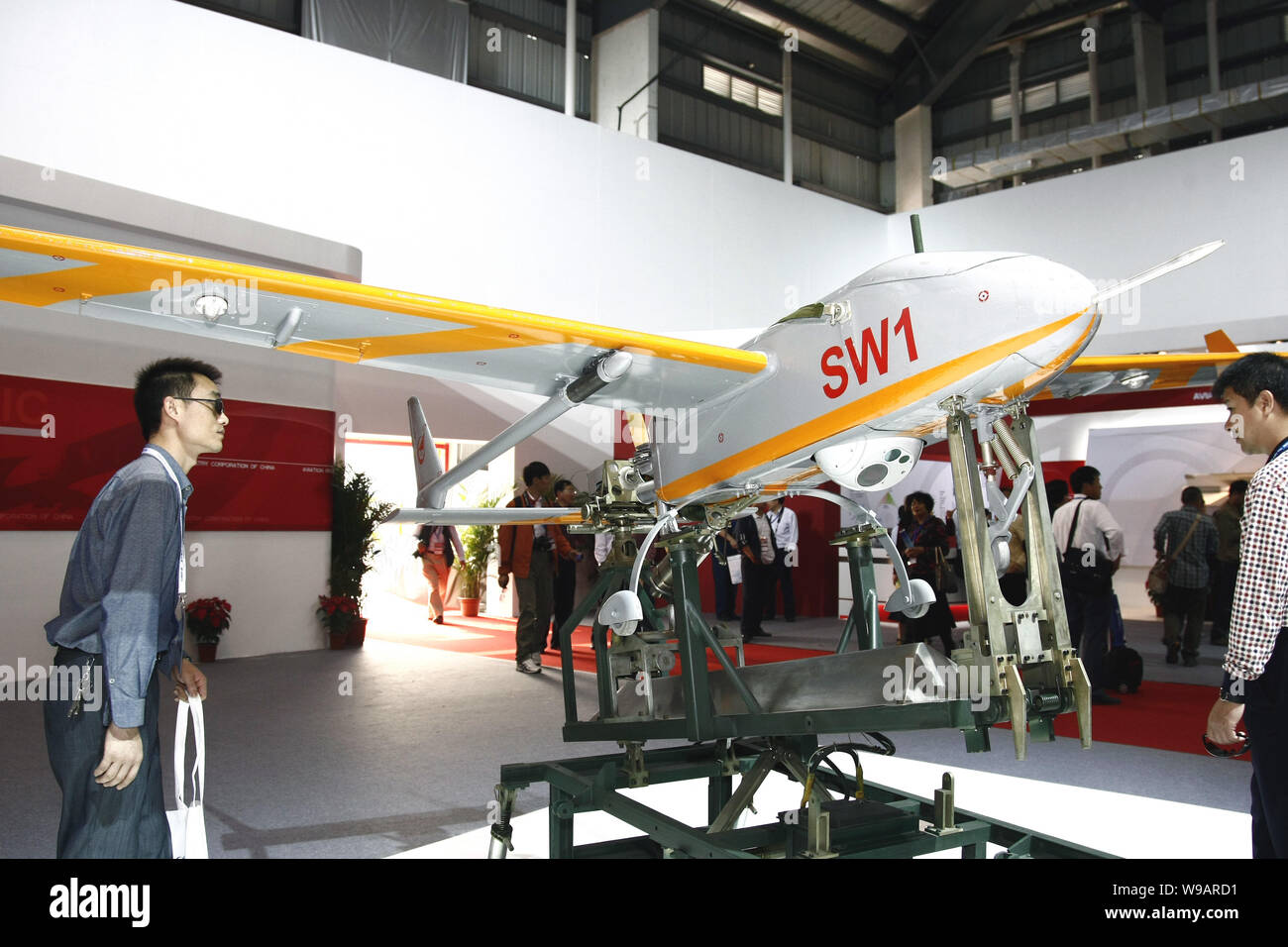 Visitors look at a model of a pilotless plane during the 8th China ...