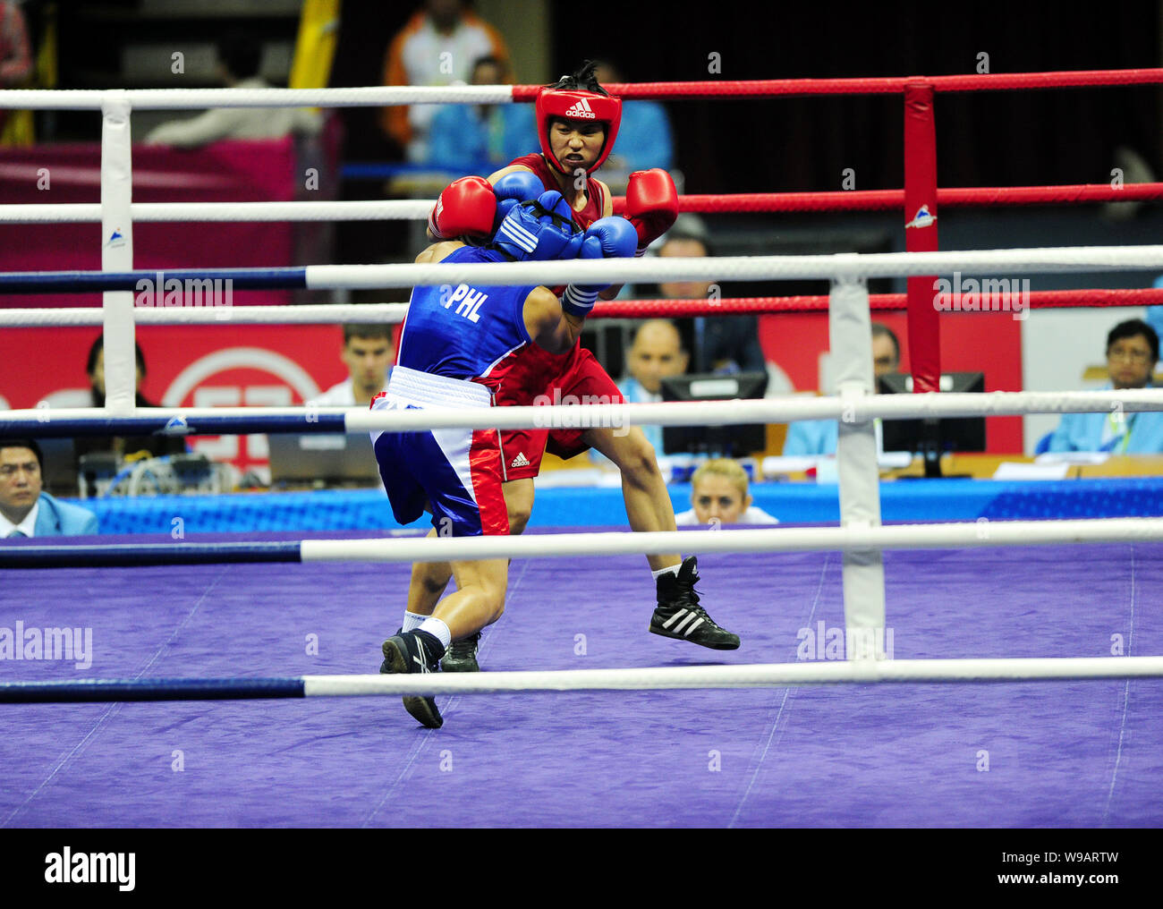 Chinas Ren Cancan, red, competes with Annie Albania of the Philippines ...