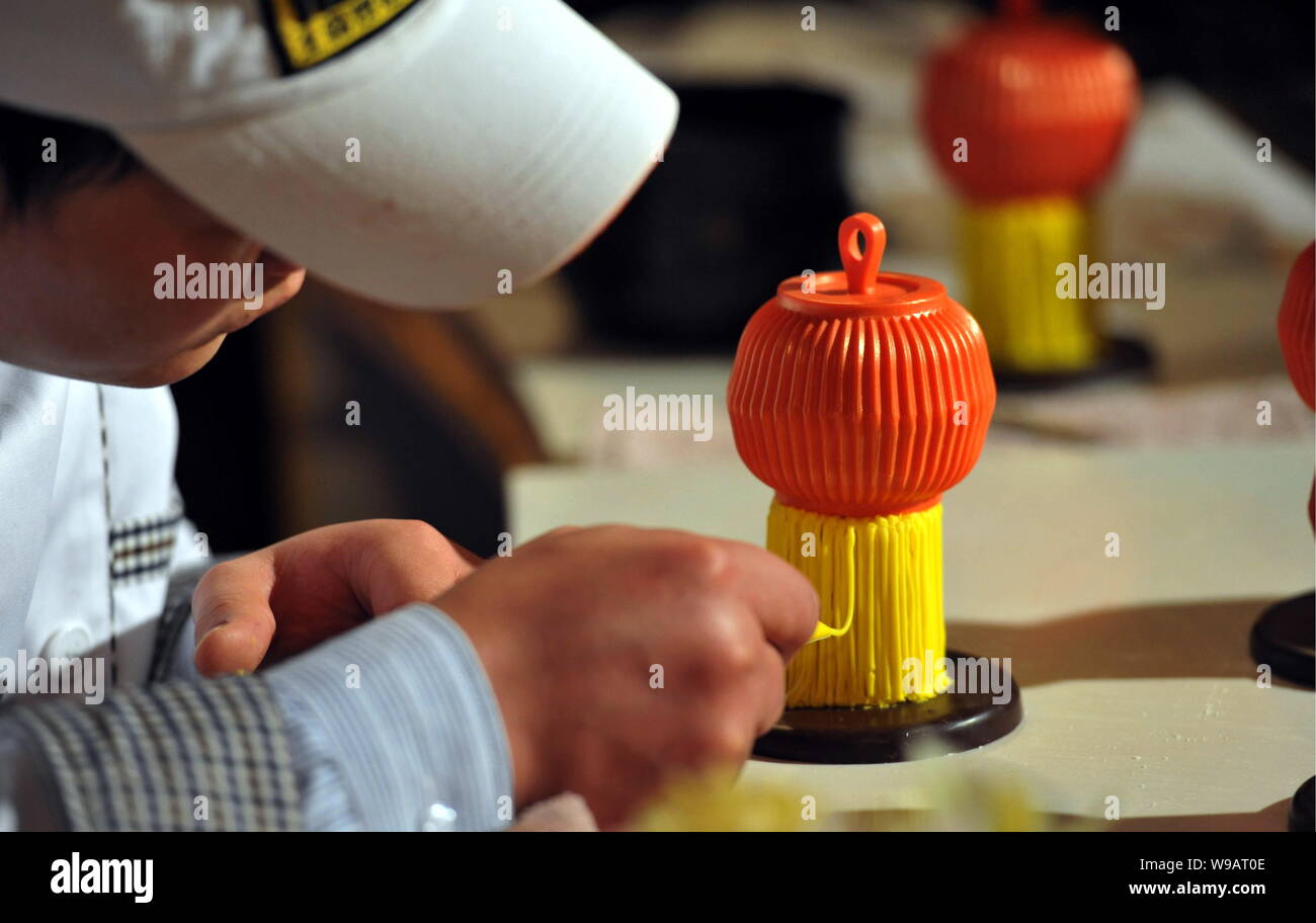 A Chinese craftsman makes red lanterns with chocolate to welcome the ...