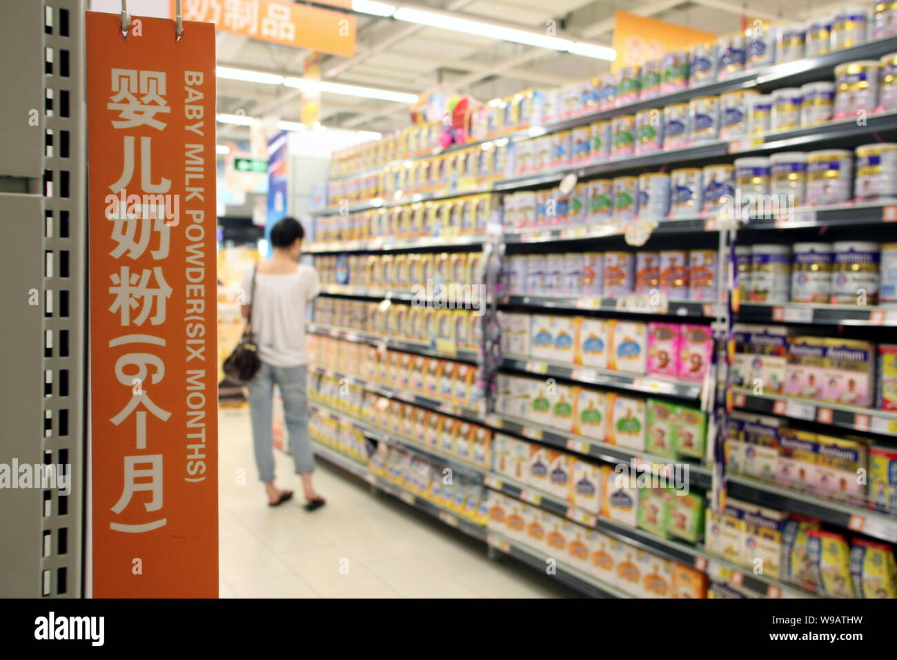 A young Chinese woman shops for milk powder at a supermarket in ...