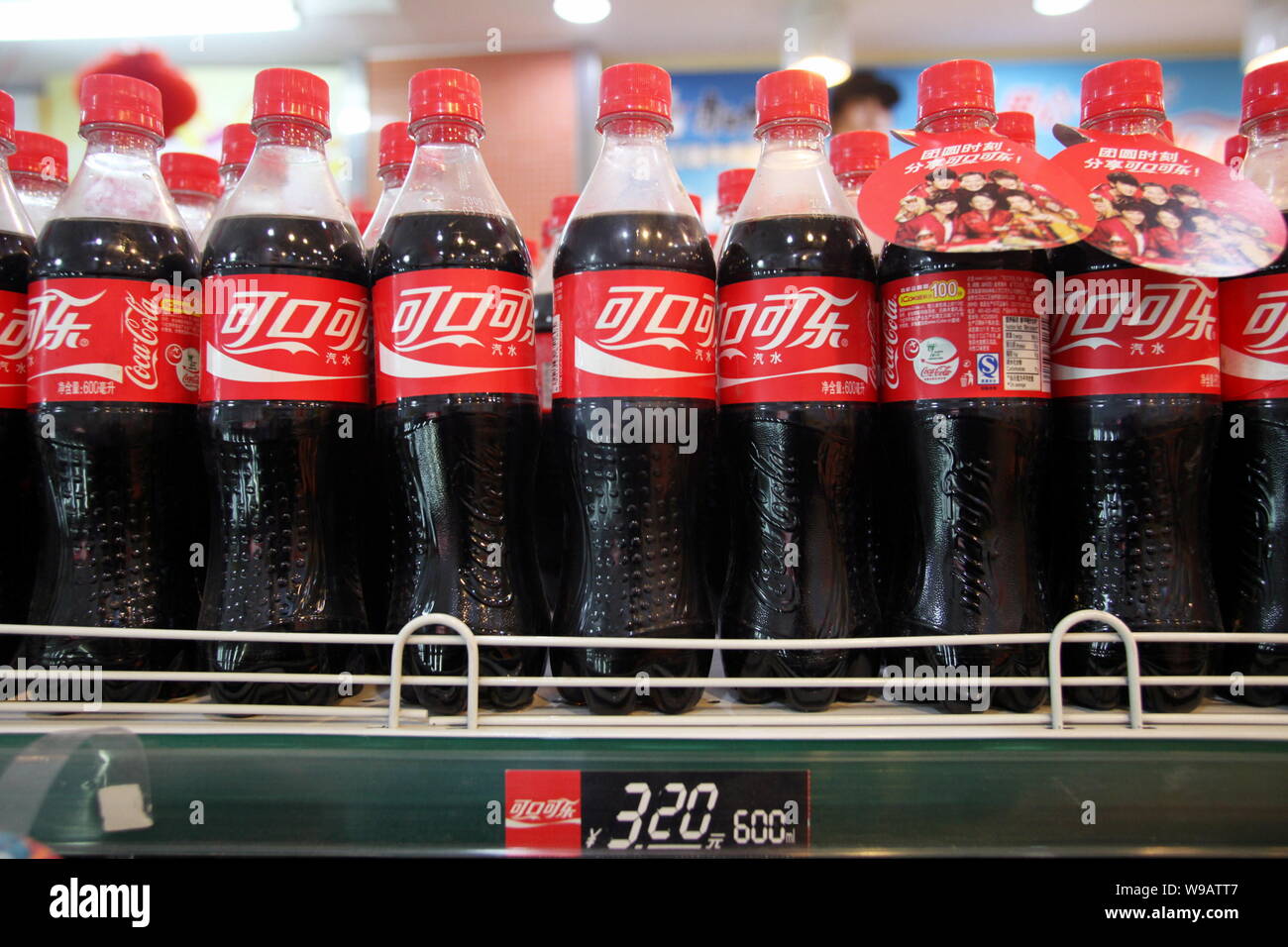 Bottles of Coca-Cola coke are seen for sale at a supermarket in ...