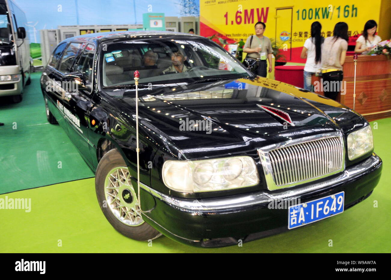 Visitors look at a Hongqi (Red Flag) electric limousine during the 2010 ...