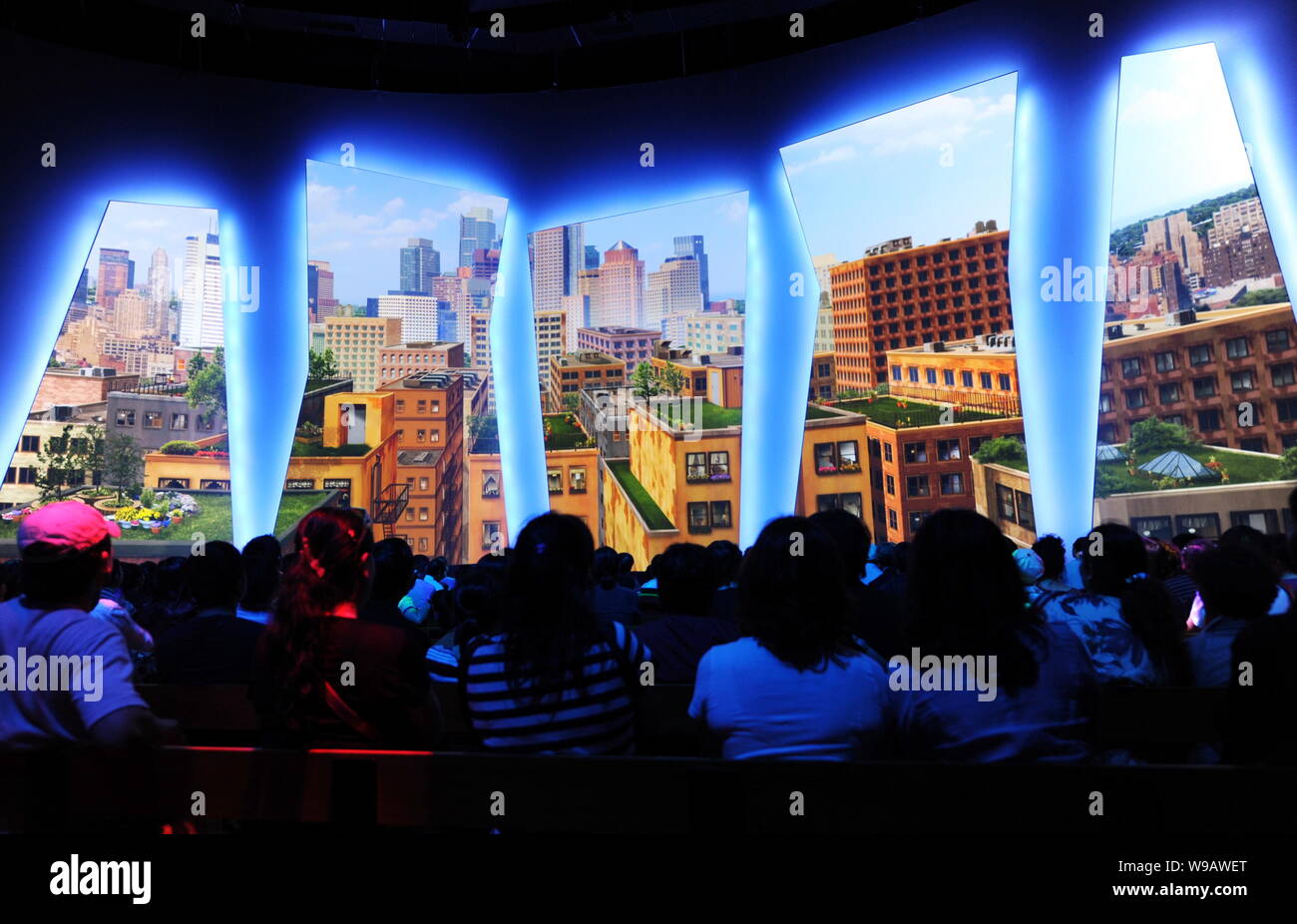 Visitors watch the 4D movie, The Garden, in the USA Pavilion in the ...