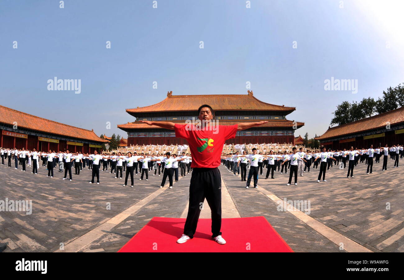 Chinese participants do a synchronized physical exercise during a ...