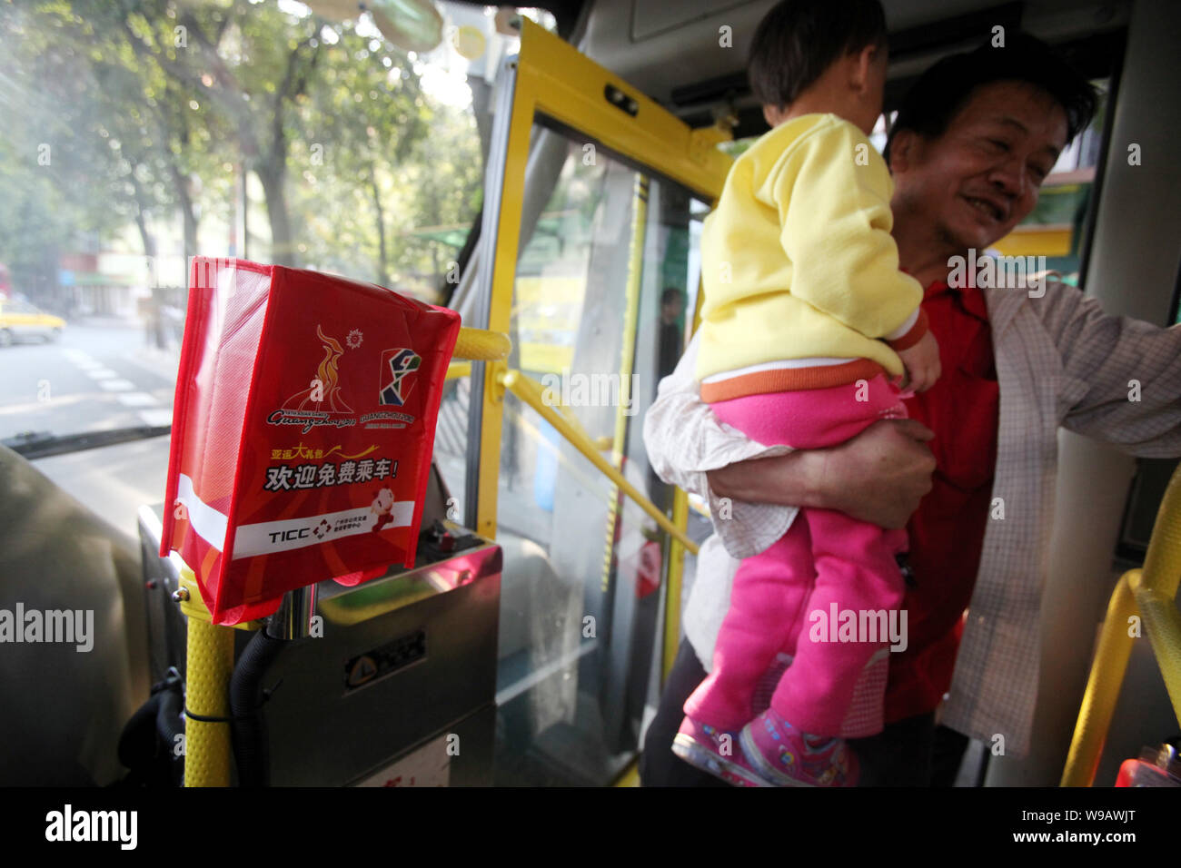 Chinese passengers take a free ride on a bus on the first free public ...