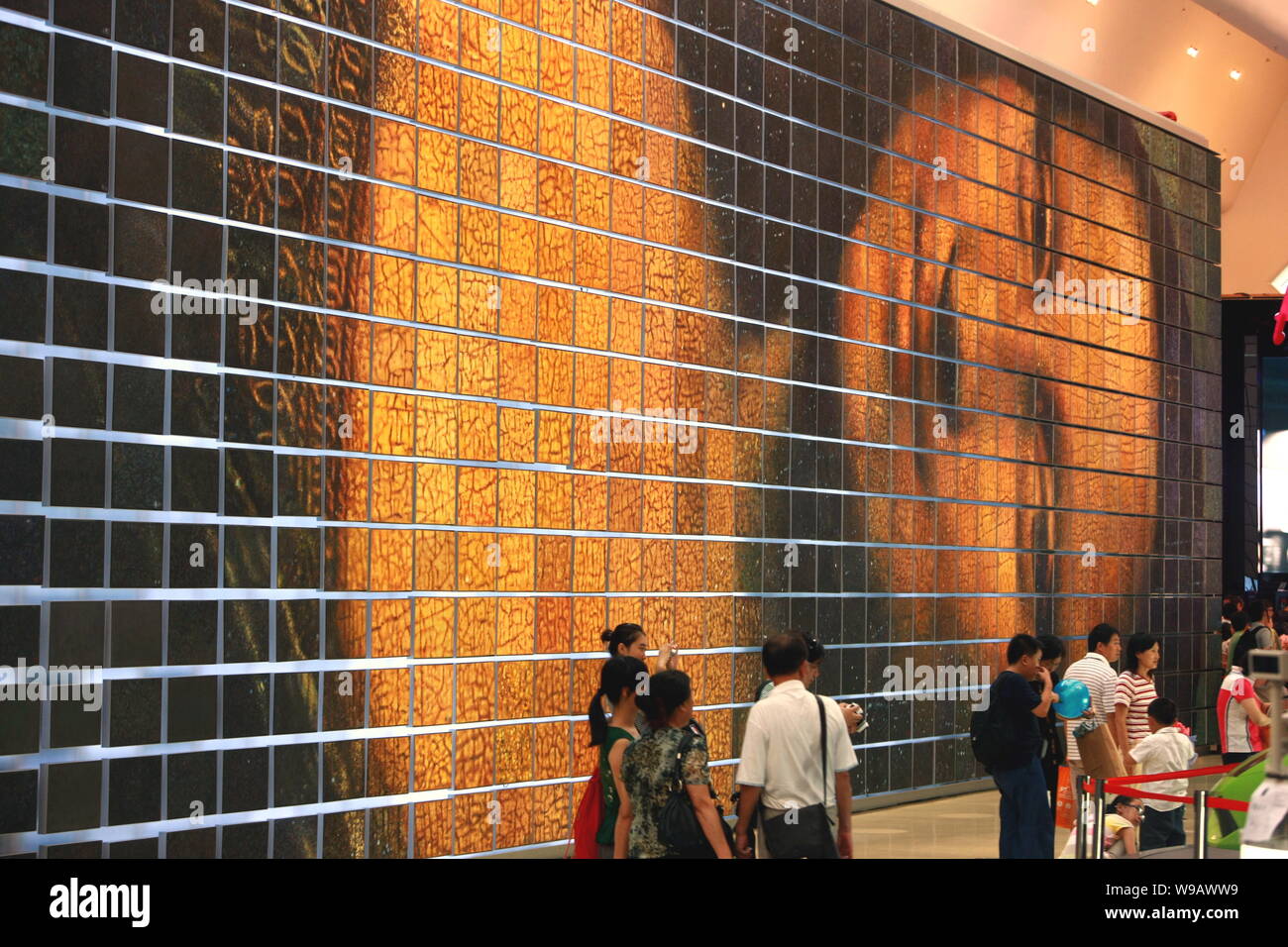 Visitors walk past a huge portrait of Mona Lisa which is made up of 999 ...