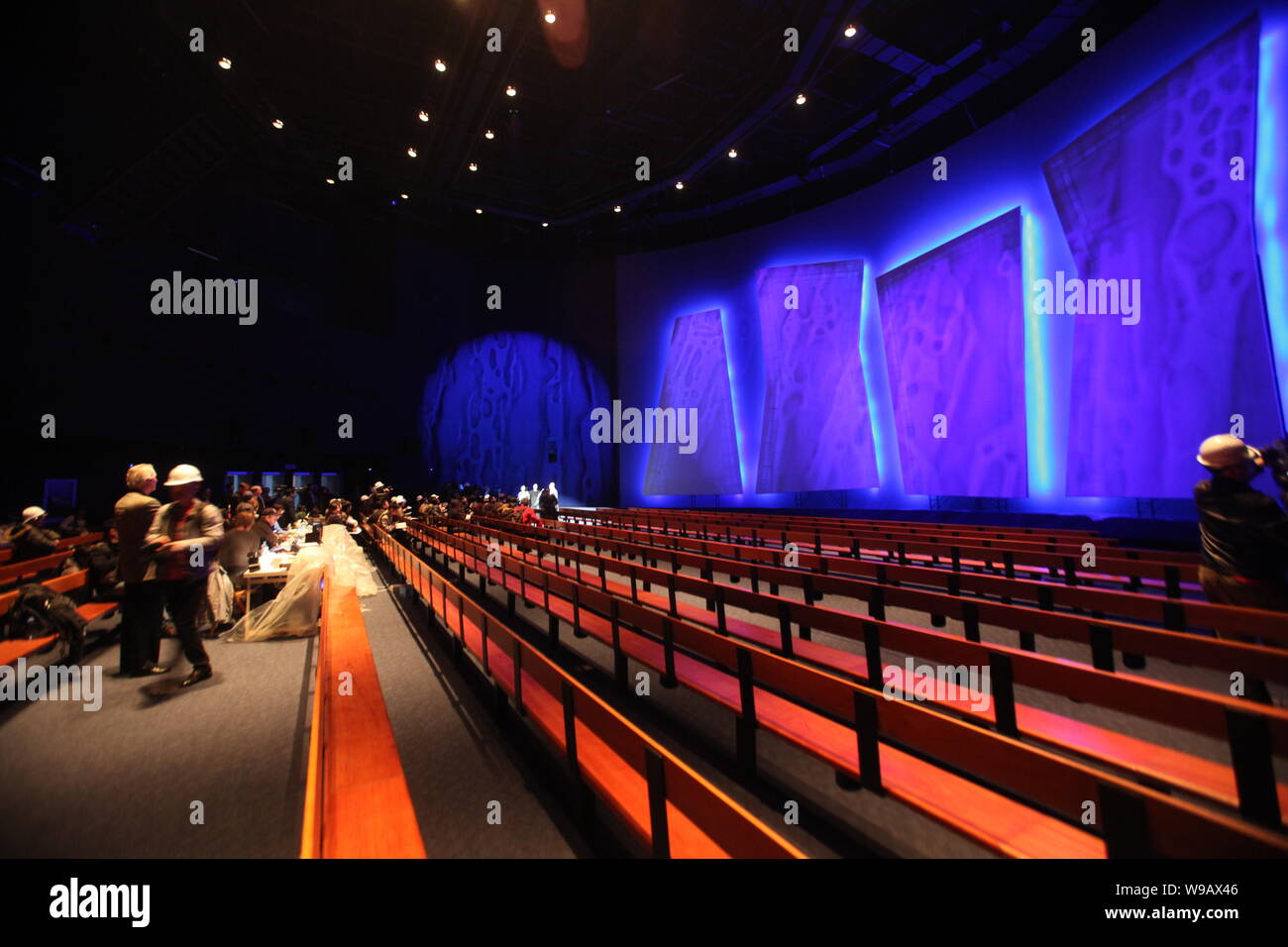 Journalists look at illuminated screens inside the USA Pavilion in the ...