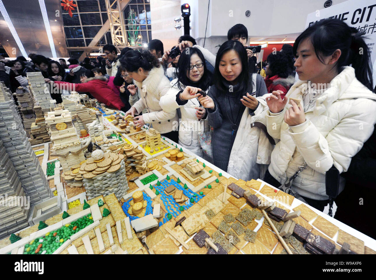 Visitors eat biscuits taken from a model of Shanghai and other ...