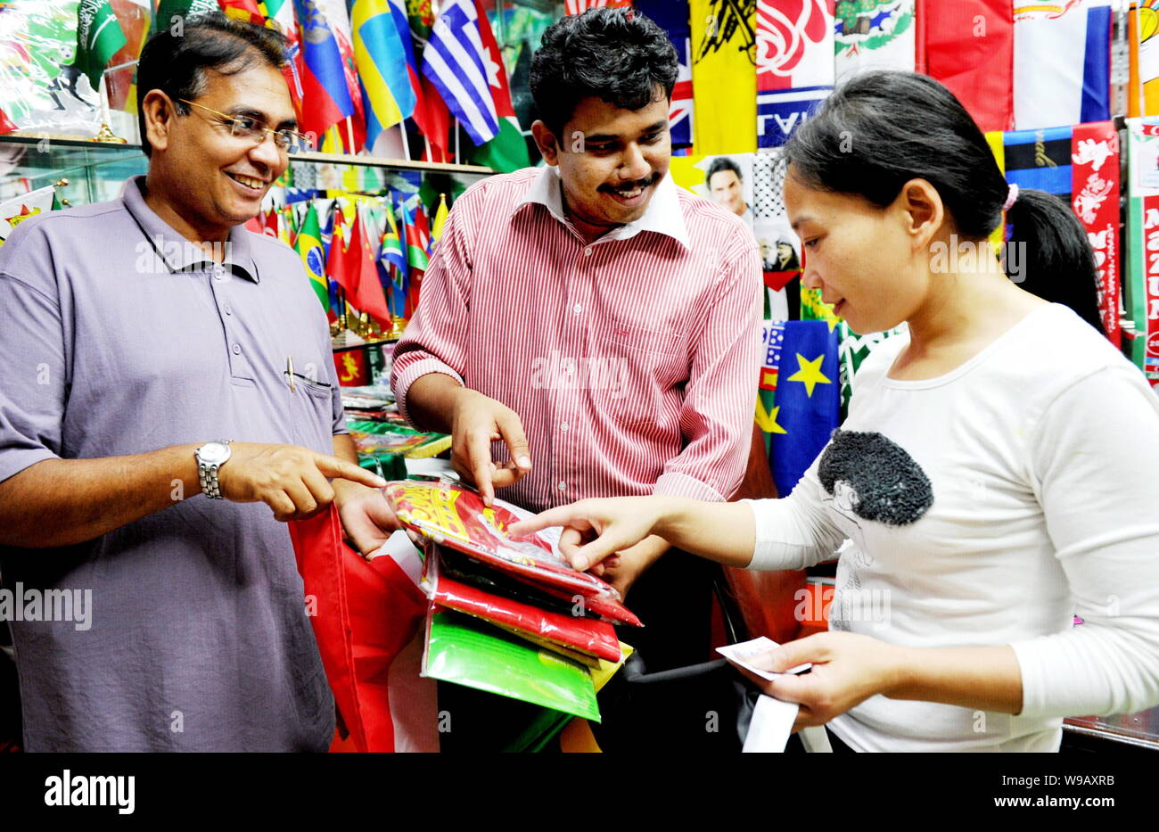 --FILE--A Chinese merchant, right, negotiates with foreigh buyers on ...