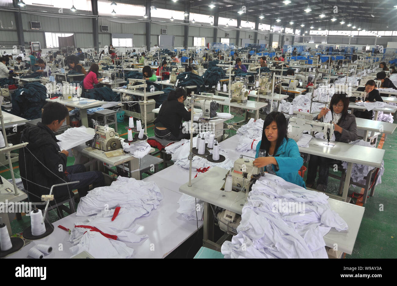 Chinese factory workers make clothes at a garment factory in Fuyang ...