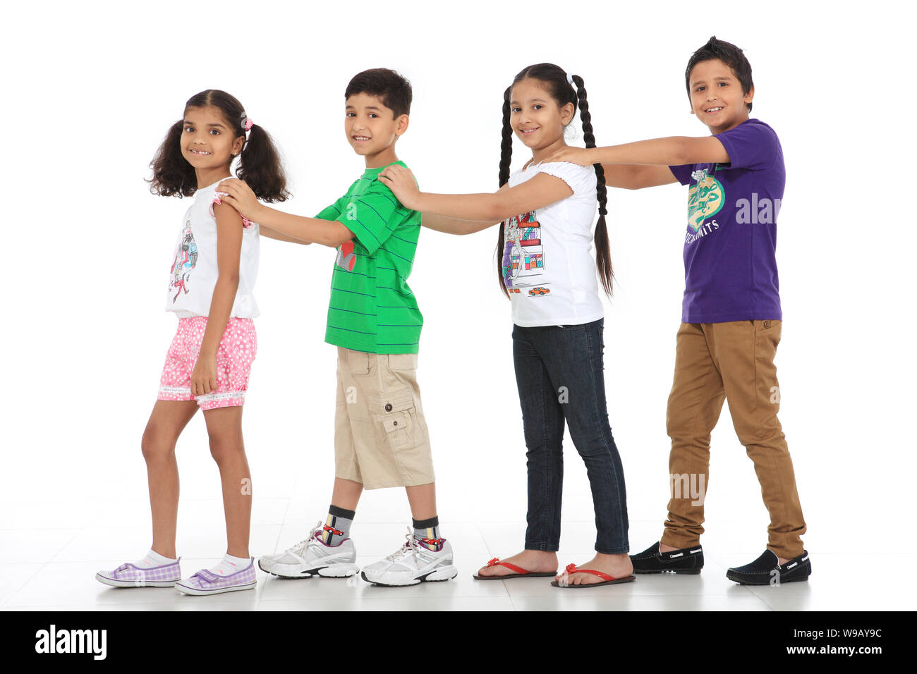 Group of children playing in a row Stock Photo - Alamy