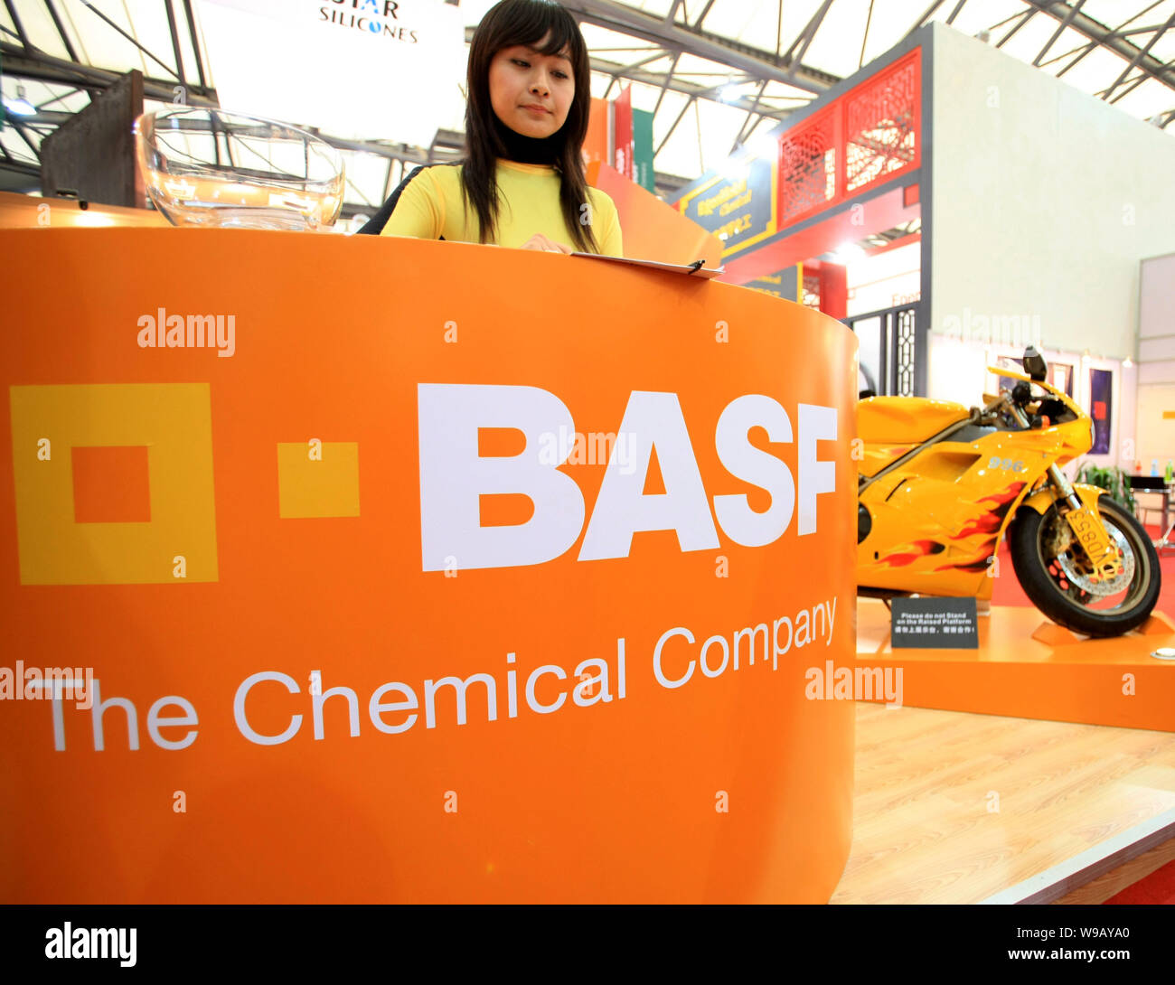 --FILE--A Chinese staff stands on the booth of BASF during a fair in ...