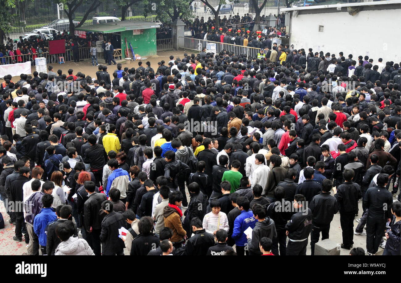 Crowds of job seekers queue up to apply for jobs during a recruitment ...