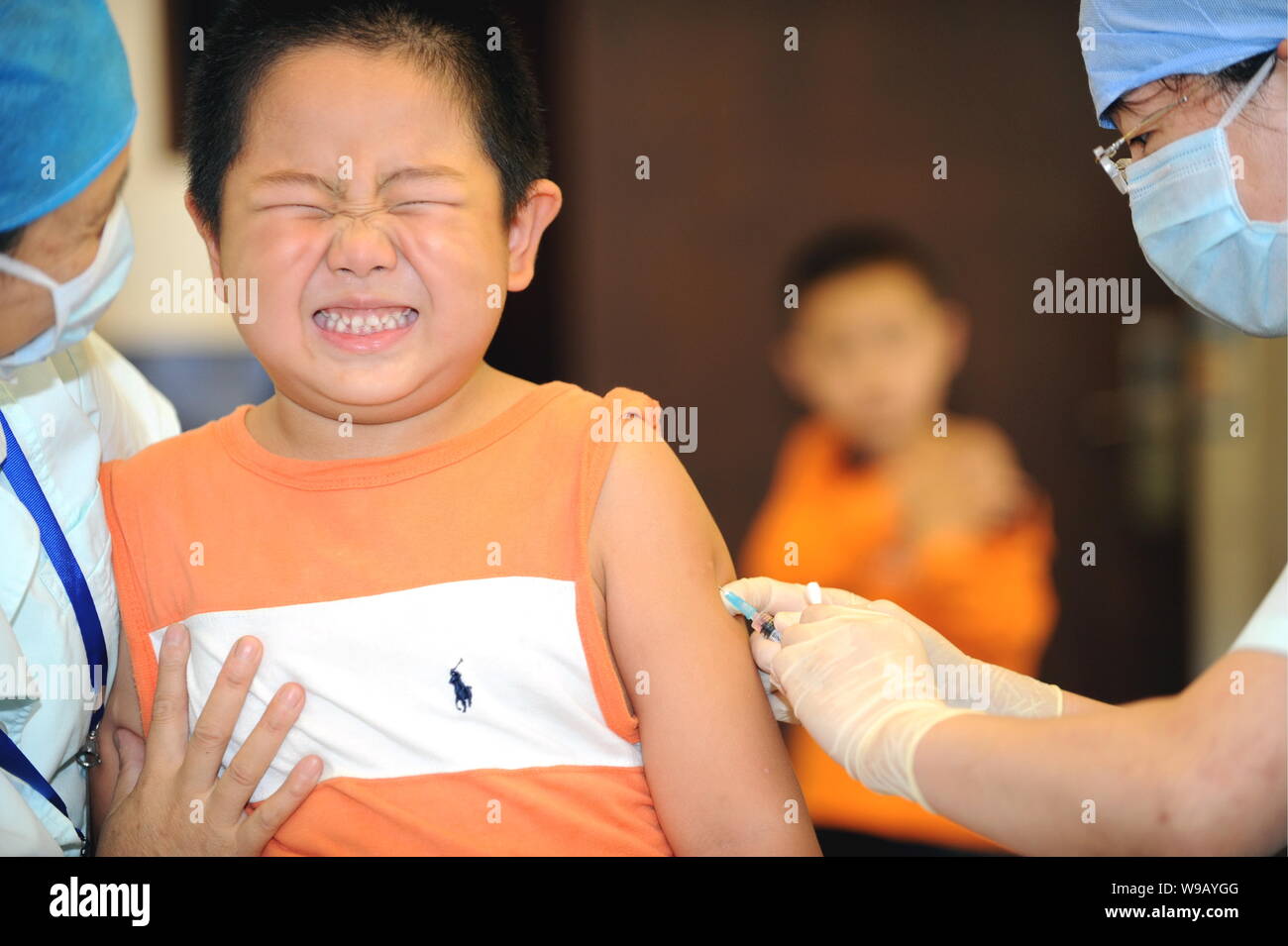 A Chinese nurse vaccinates a young Chinese boy against measles at a ...