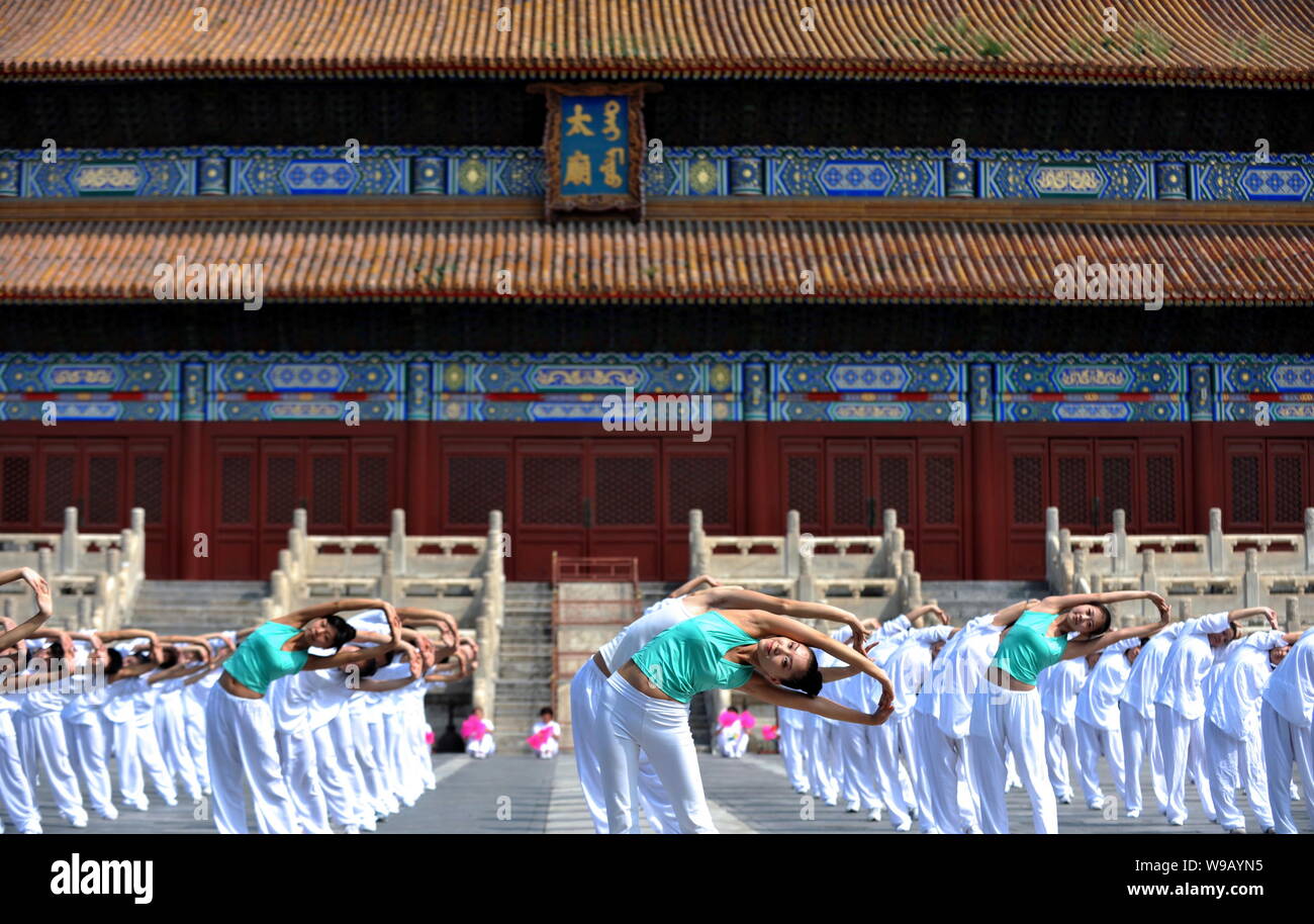 Chinese participants do a synchronized physical exercise during a ...