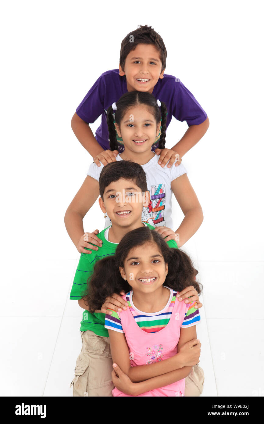 Group of children sitting in a queue Stock Photo - Alamy