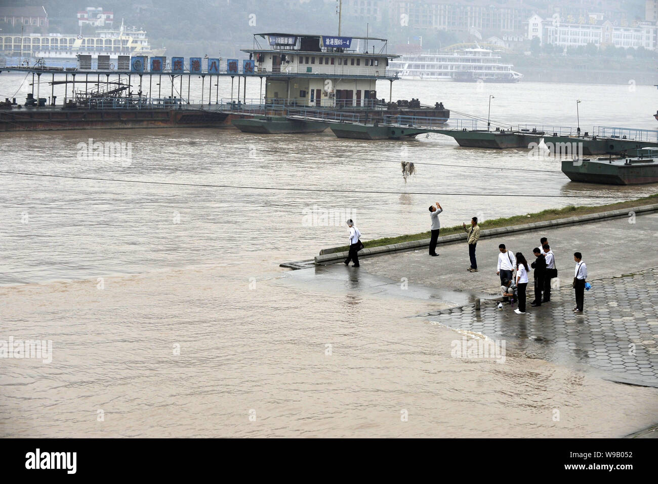 Local Chinese residents stand at the bank of the Yangtze River in ...