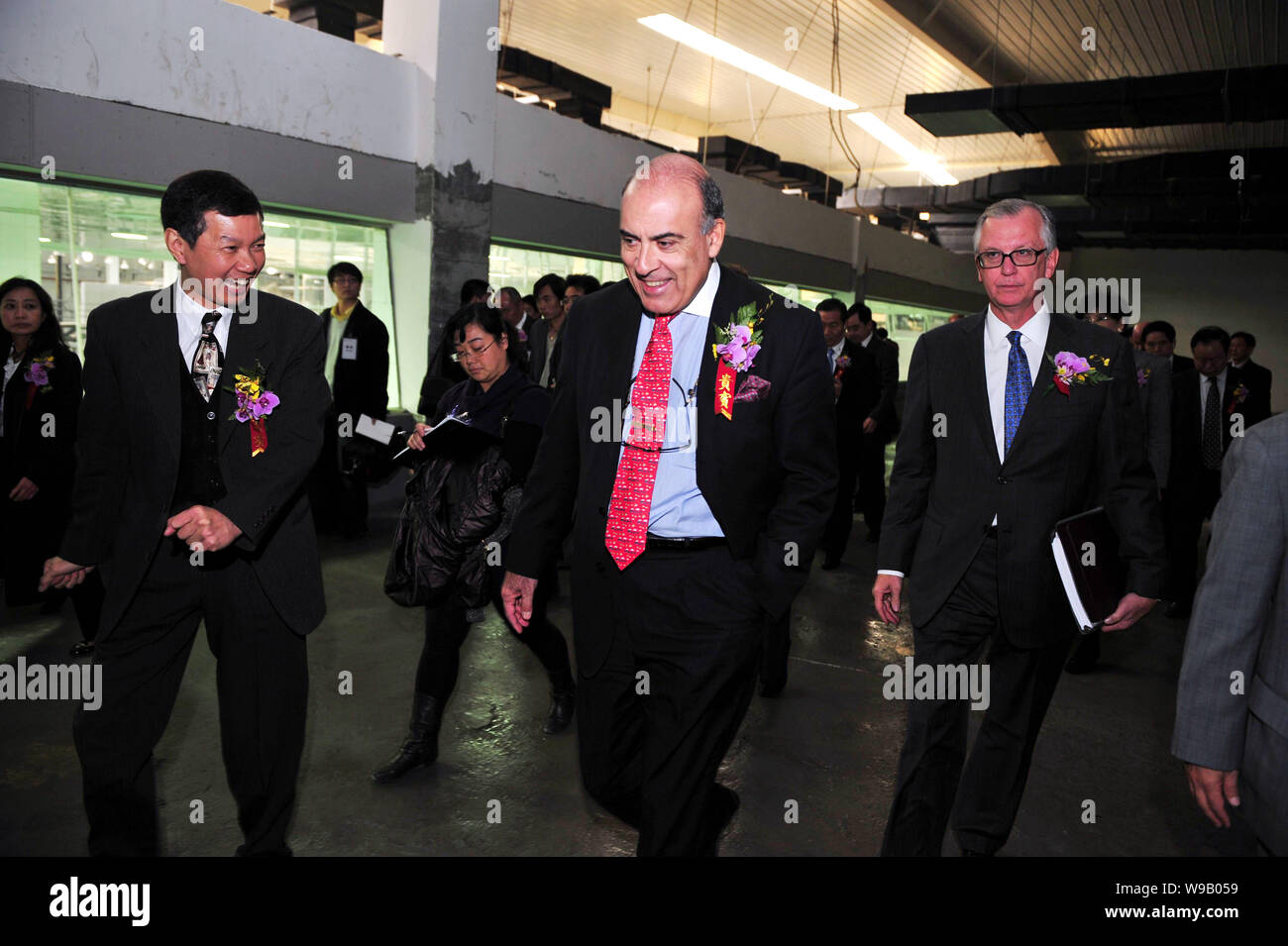 Muhtar Kent, center, Chairman and CEO of The Coca-Cola Company, visits ...
