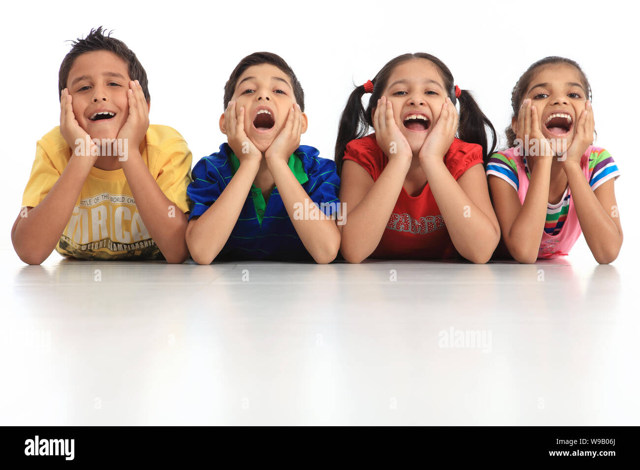 Group of children lying on floor side by side Stock Photo - Alamy