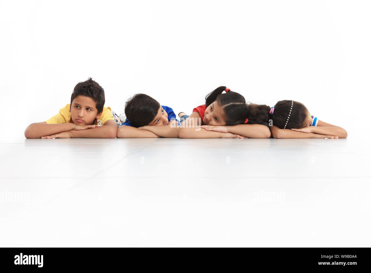 Brother sister sleeping on floor Cut Out Stock Images & Pictures - Alamy