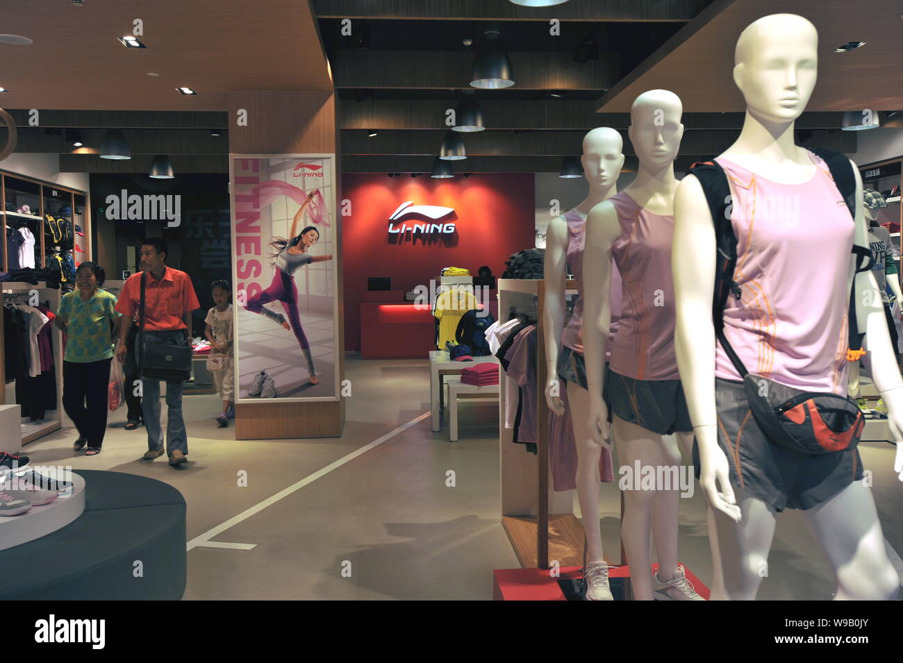 Chinese consumers shop for clothes at a Li Ning sprotswear store in ...