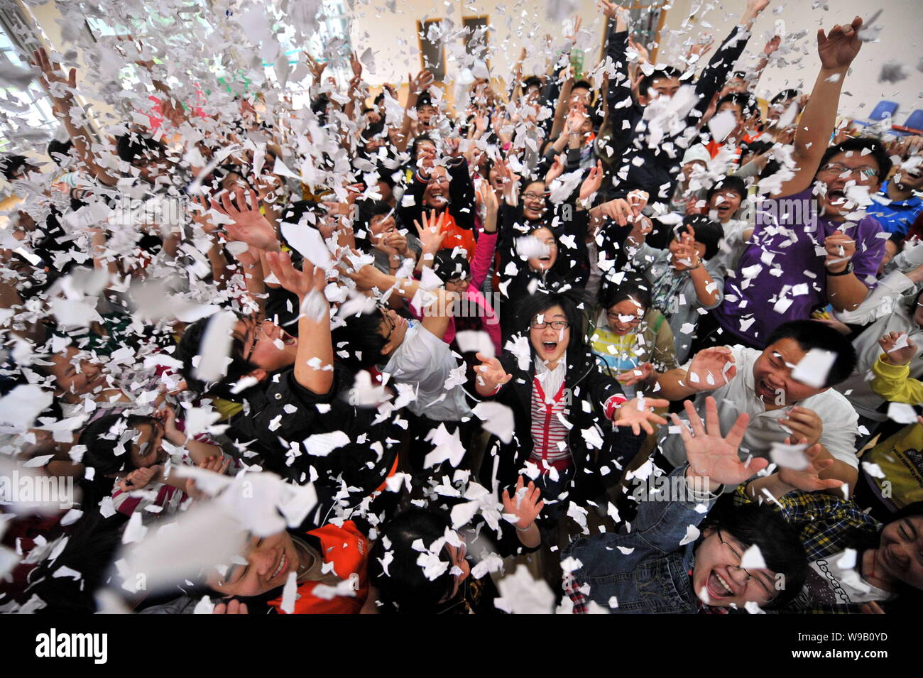 Chinese students throw confetti to vent stress during an activity ...
