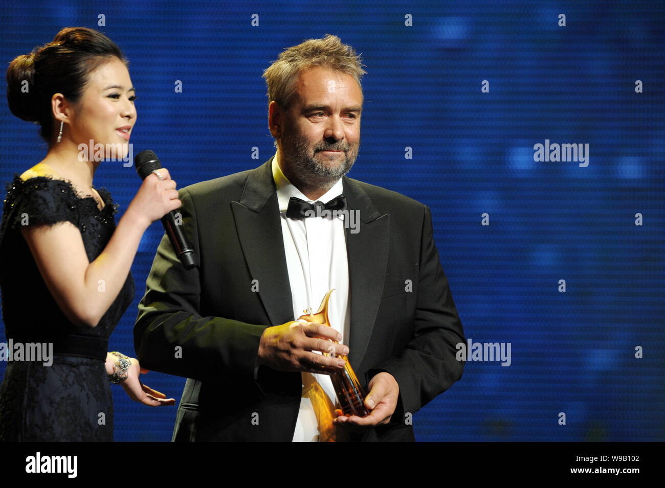 French film director Luc Besson poses after being awarded the ...
