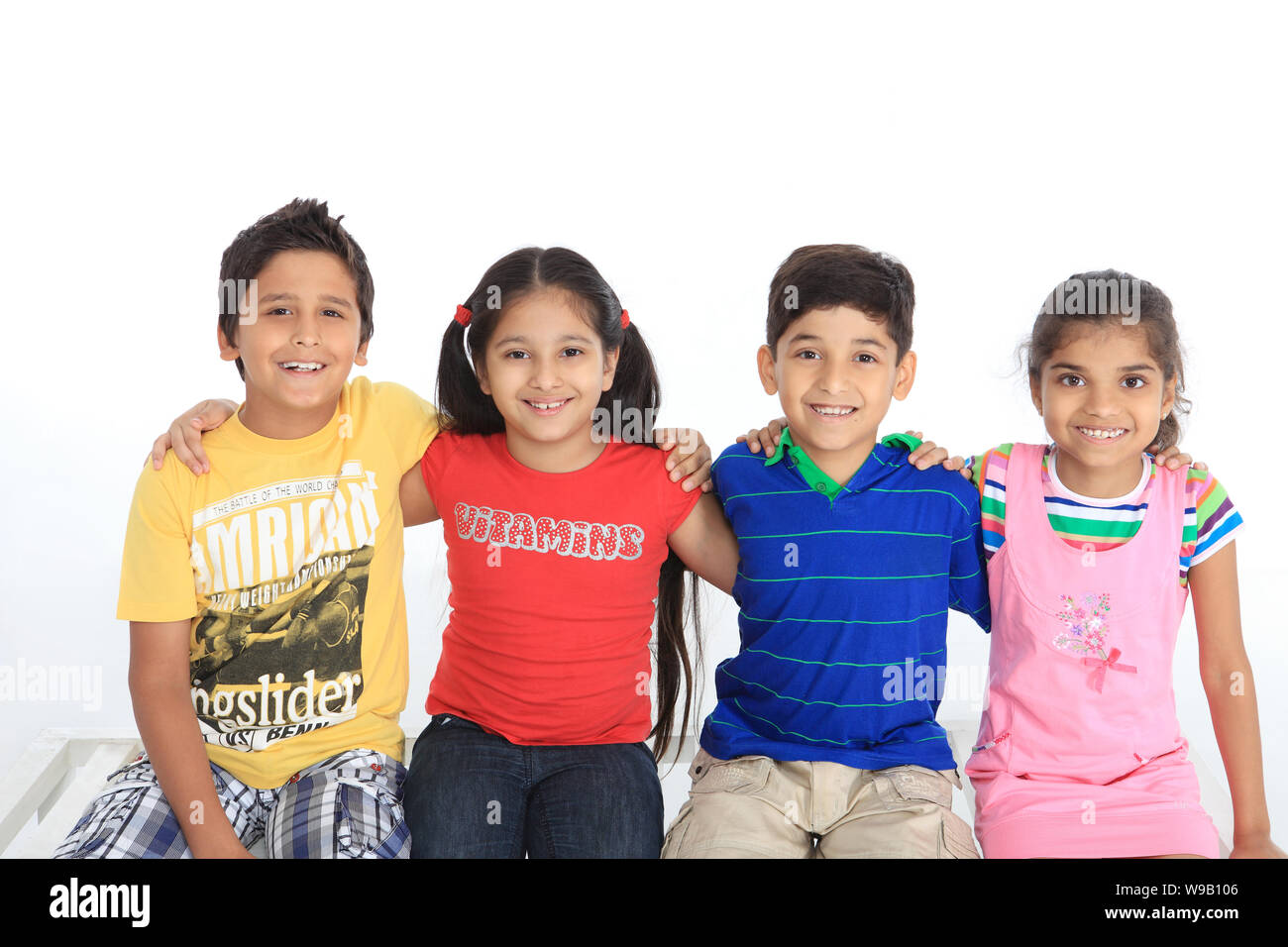 Group of children sitting together and smiling Stock Photo - Alamy