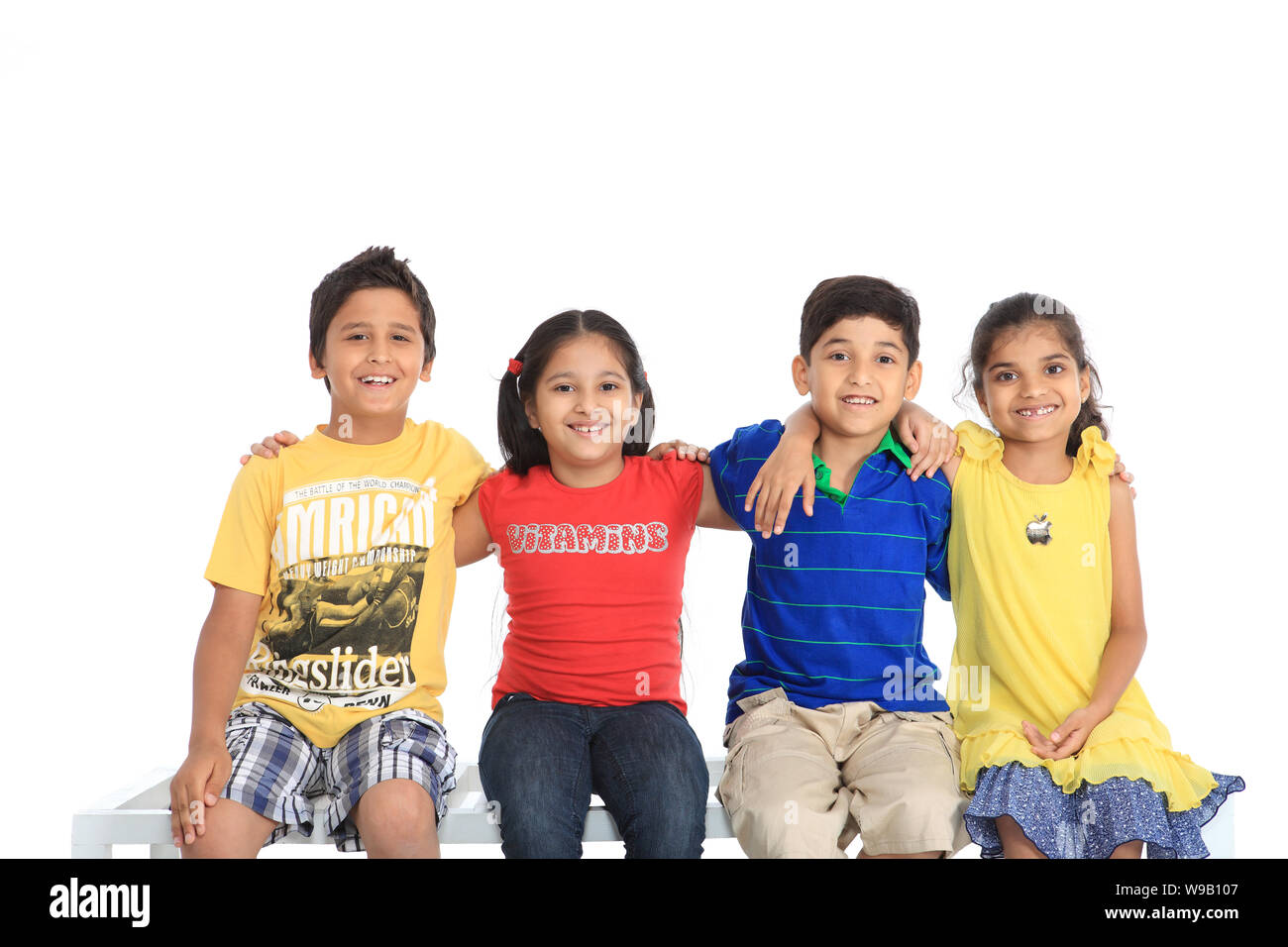 Group of children sitting together and smiling Stock Photo - Alamy