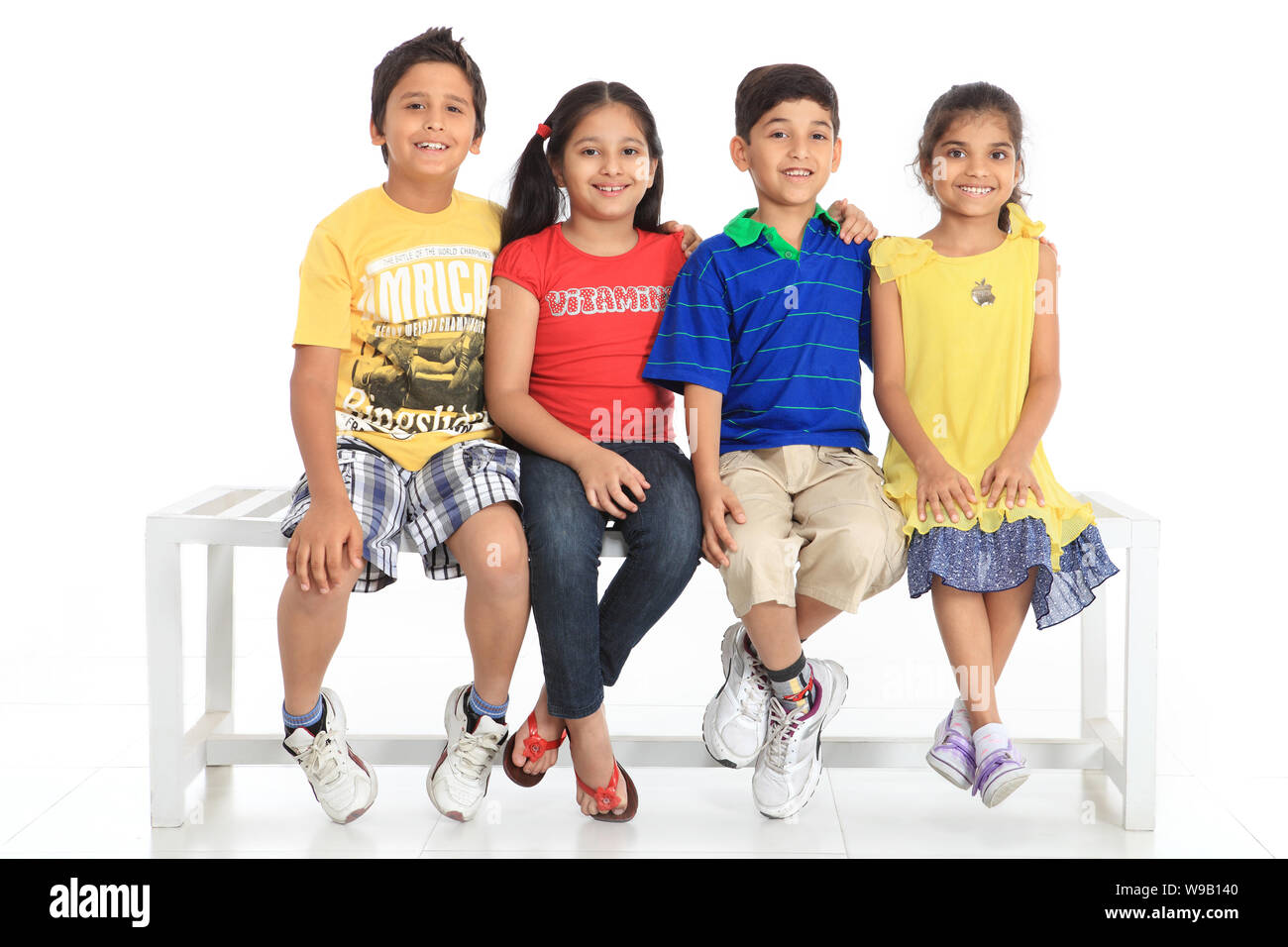 Group of children sitting together and smiling Stock Photo - Alamy