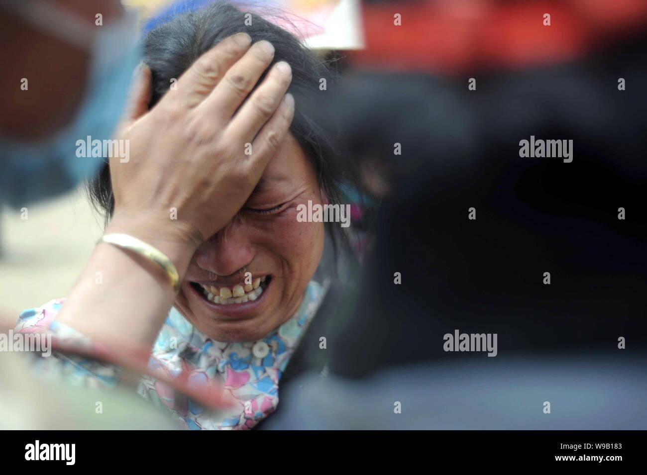 A Chinese Tibetan woman cries over her daughter injured in the 7.1 ...