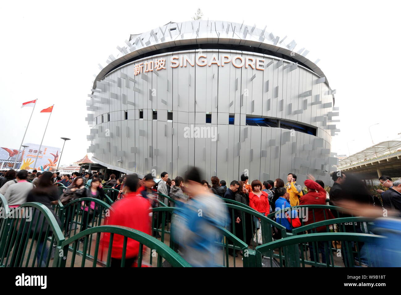Crowds of visitors queue up to enter the Singapore Pavilion during the ...